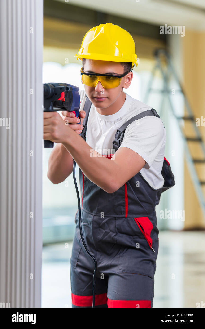 Man drilling the wall with drill perforator Stock Photo - Alamy