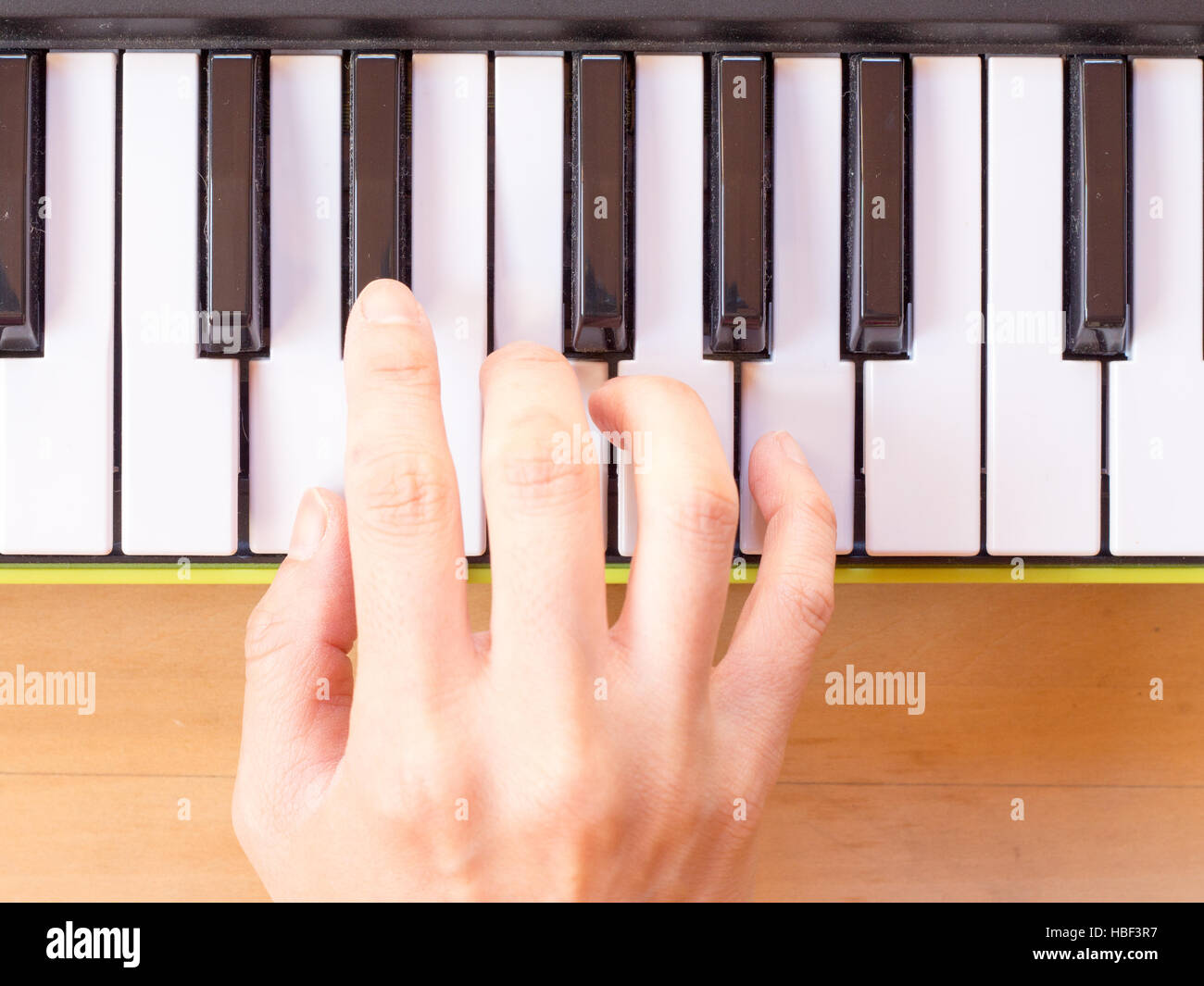 Playing mini digital piano, Dm, on wooden table Stock Photo - Alamy