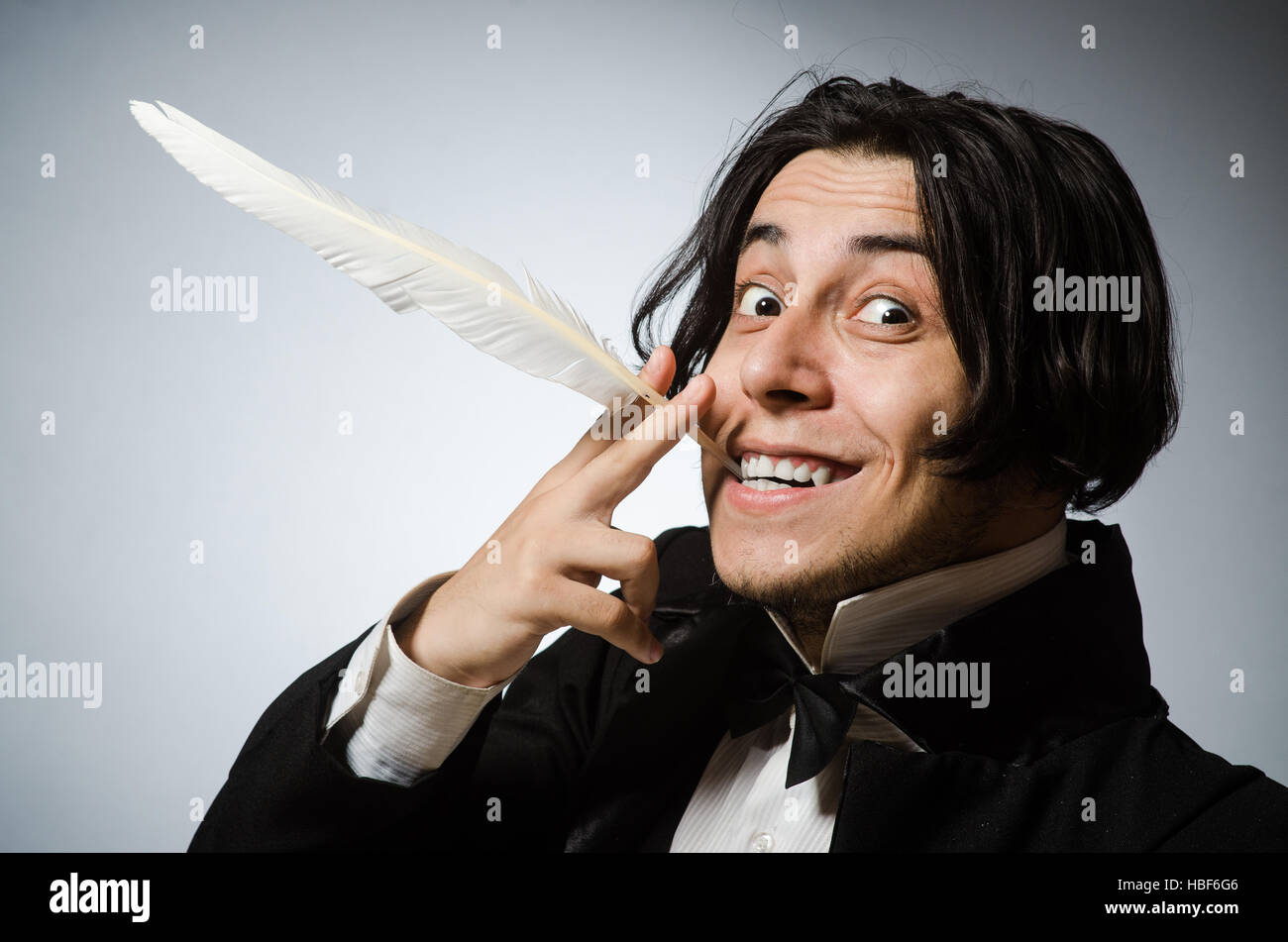 Funny writer with quill in vintage concept Stock Photo - Alamy