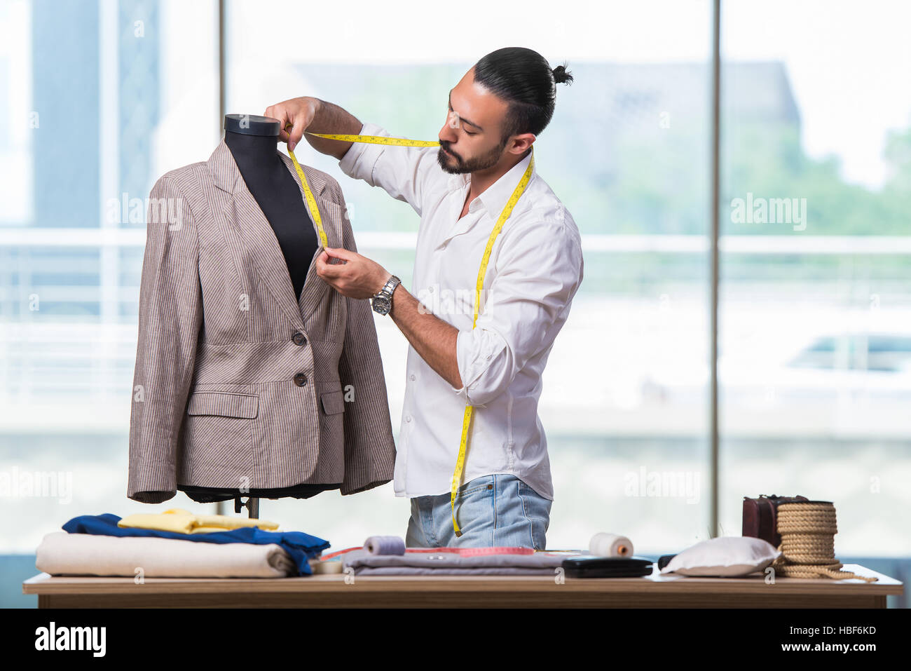 Young tailor working on new clothing design Stock Photo - Alamy