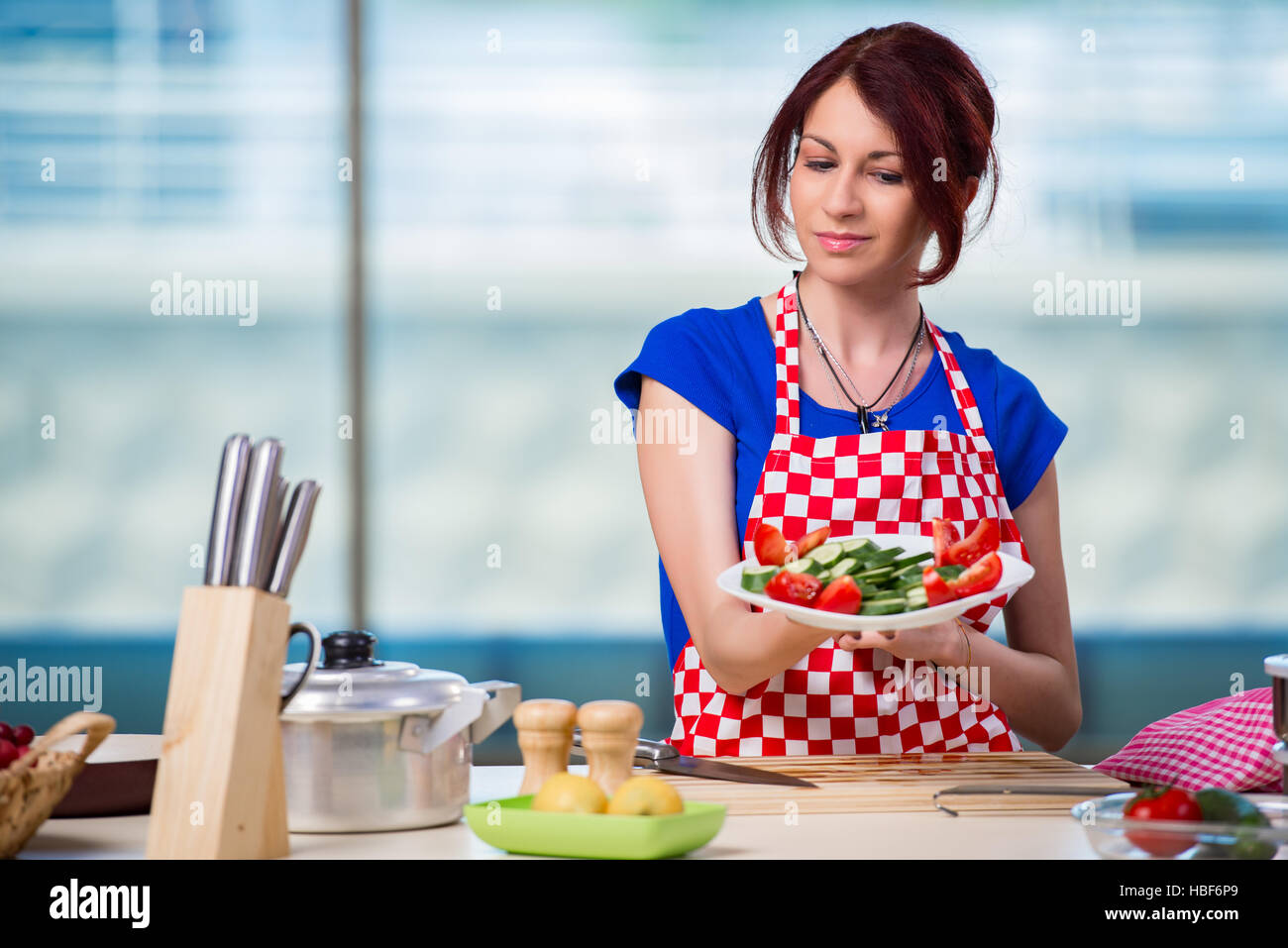 Young woman working in the kitchen Stock Photo - Alamy