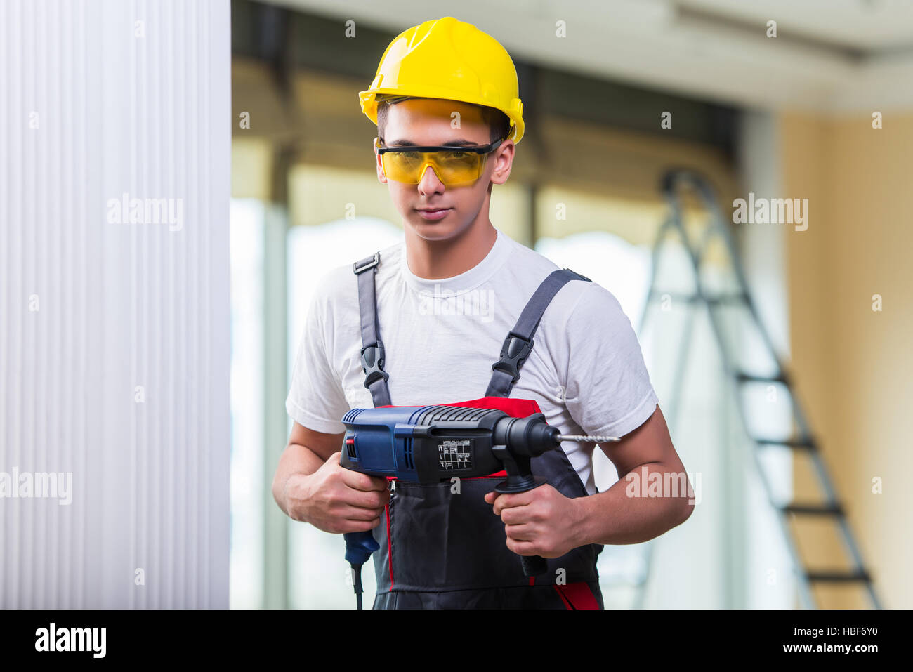 Man drilling the wall with drill perforator Stock Photo - Alamy