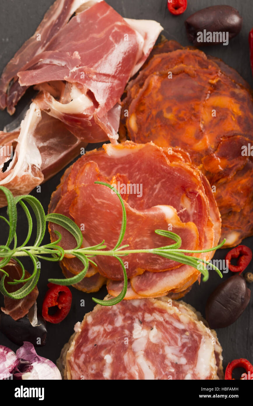 a pile of different spanish embutido, jamon, chorizo and lomo embuchado ...
