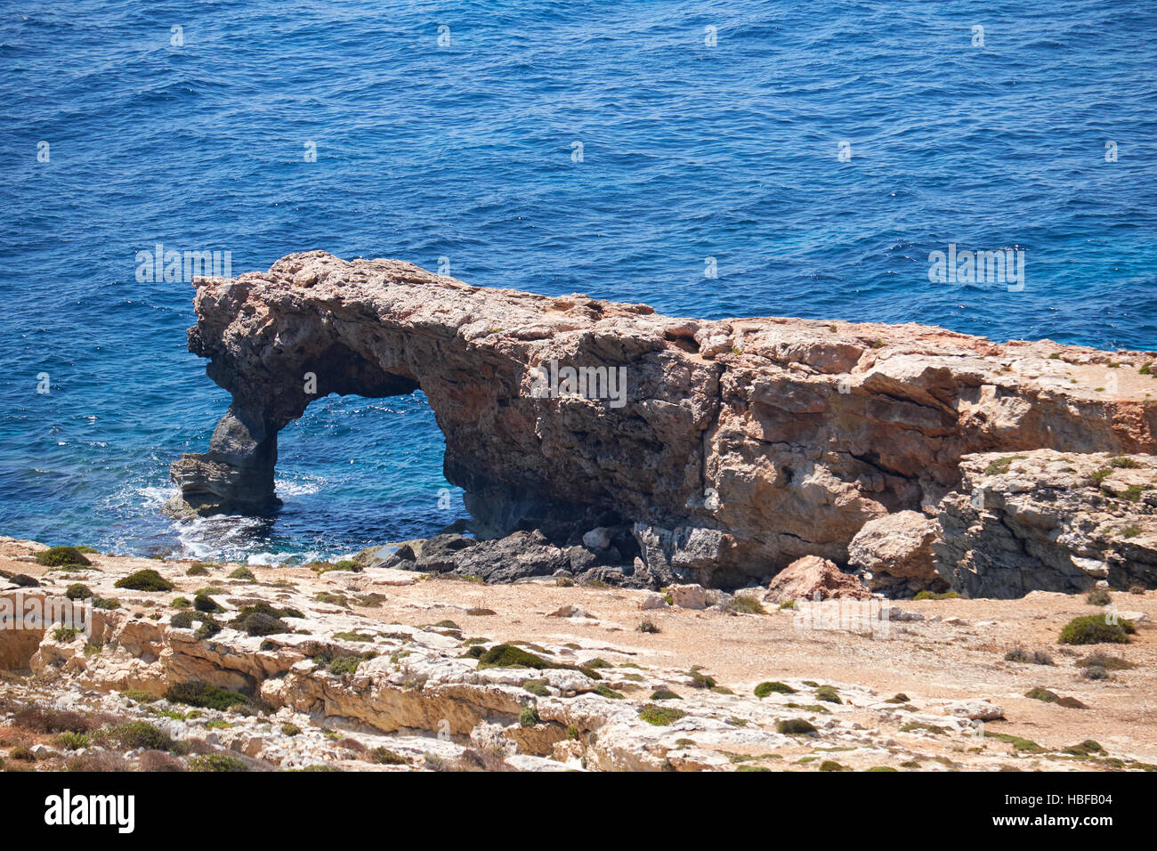 The stone arch of Ras il-Hamrija, Malta Stock Photo - Alamy