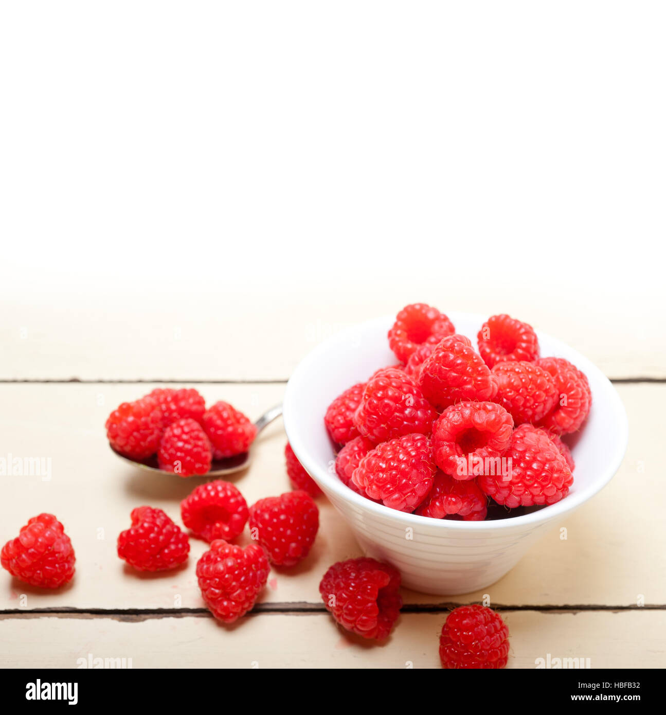 bunch of fresh raspberry on a bowl and white table Stock Photo - Alamy