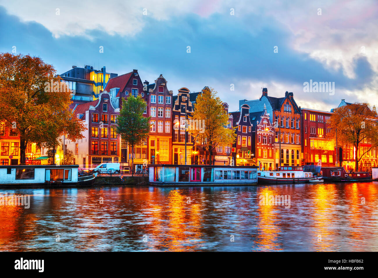 Amsterdam city view with Amstel river at sunset Stock Photo: 127571866 ...