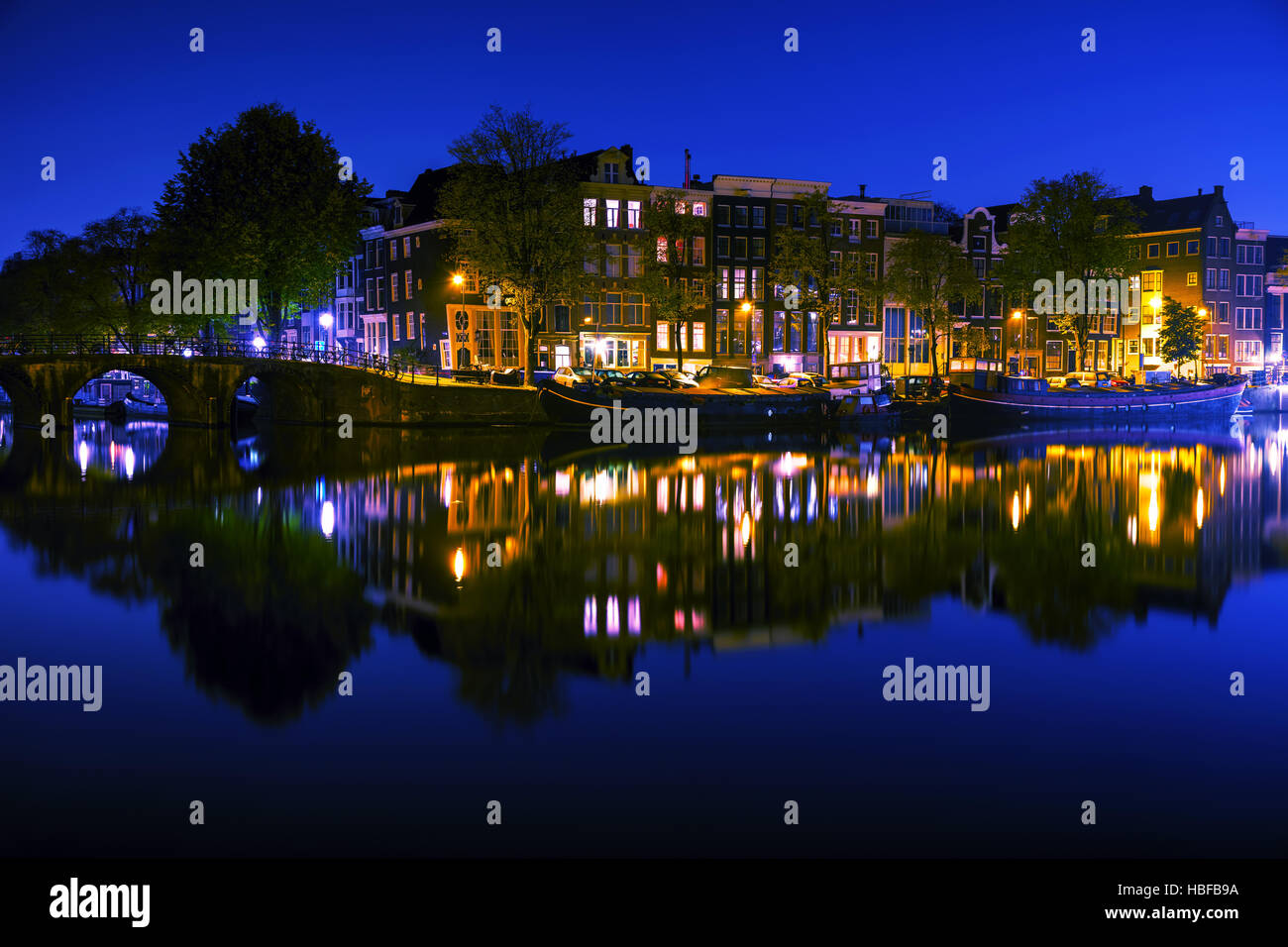 Amsterdam city view with canals and bridges at night Stock Photo - Alamy