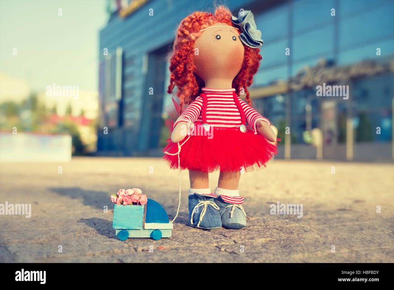 Red-haired handmade doll with a toy car Stock Photo - Alamy