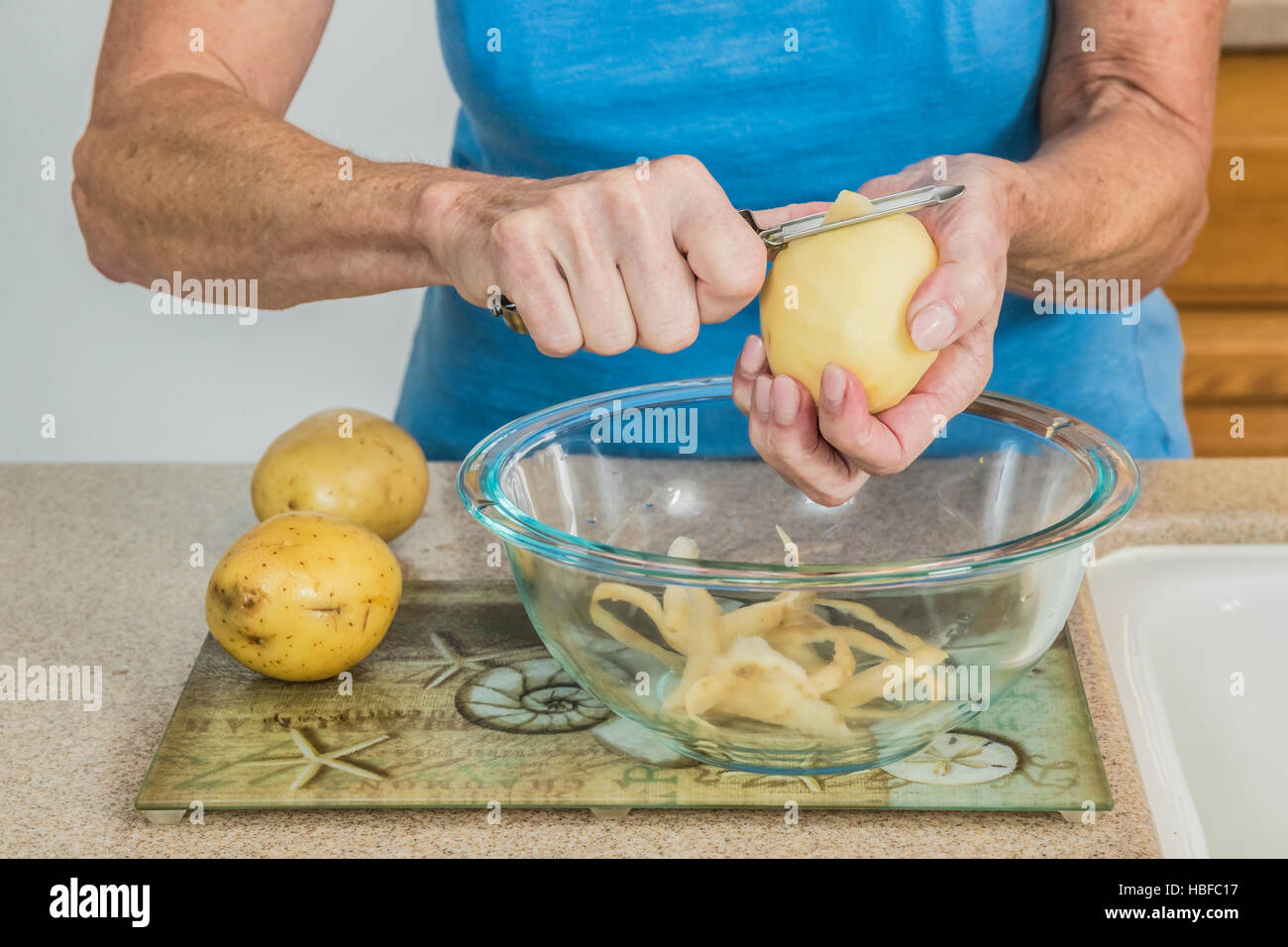 woman peeling potato Stock Photo - Alamy