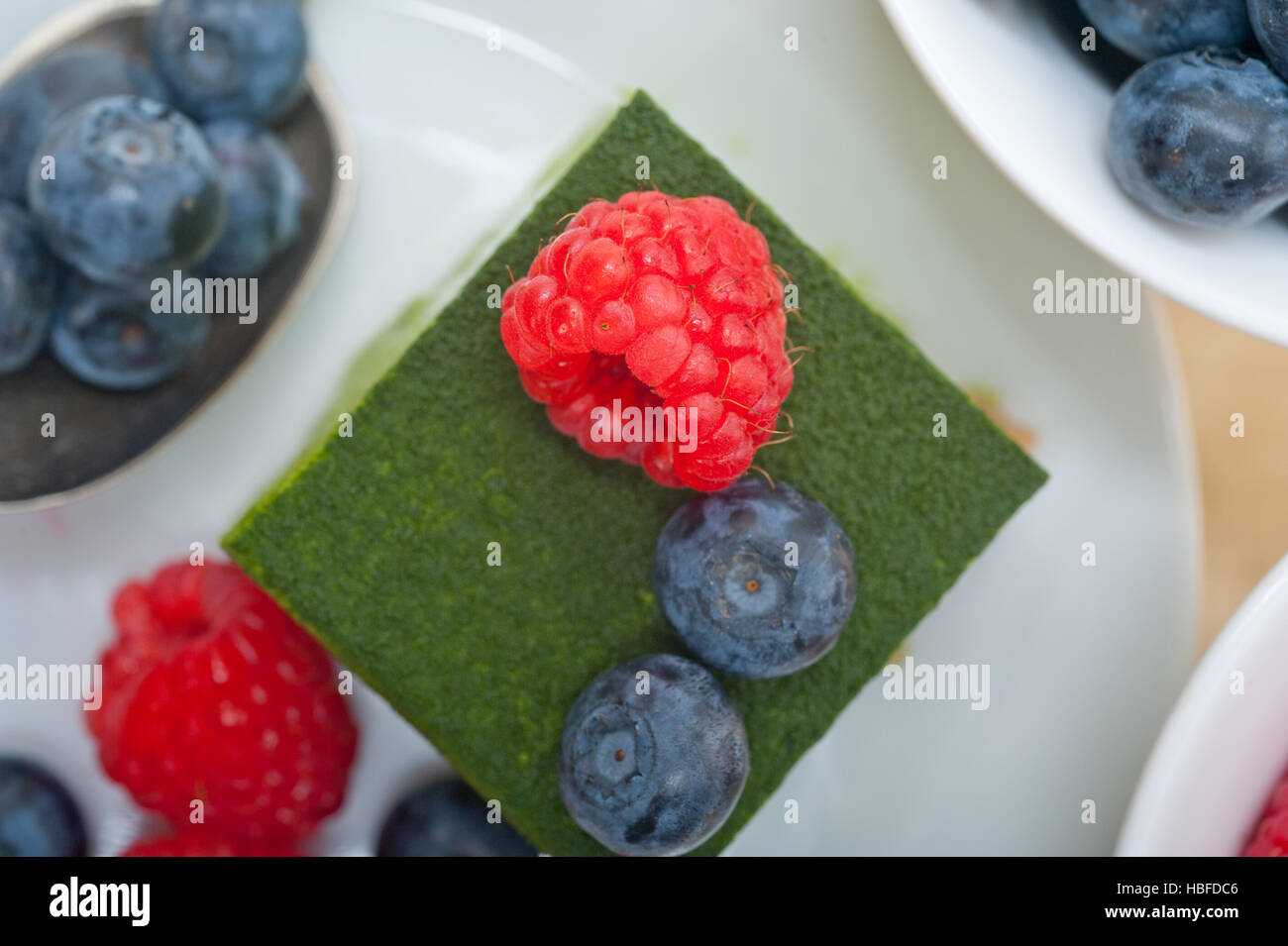 green tea matcha mousse cake with berries Stock Photo - Alamy