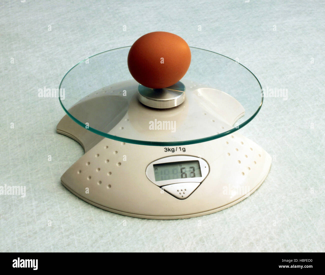 egg on scales Stock Photo - Alamy
