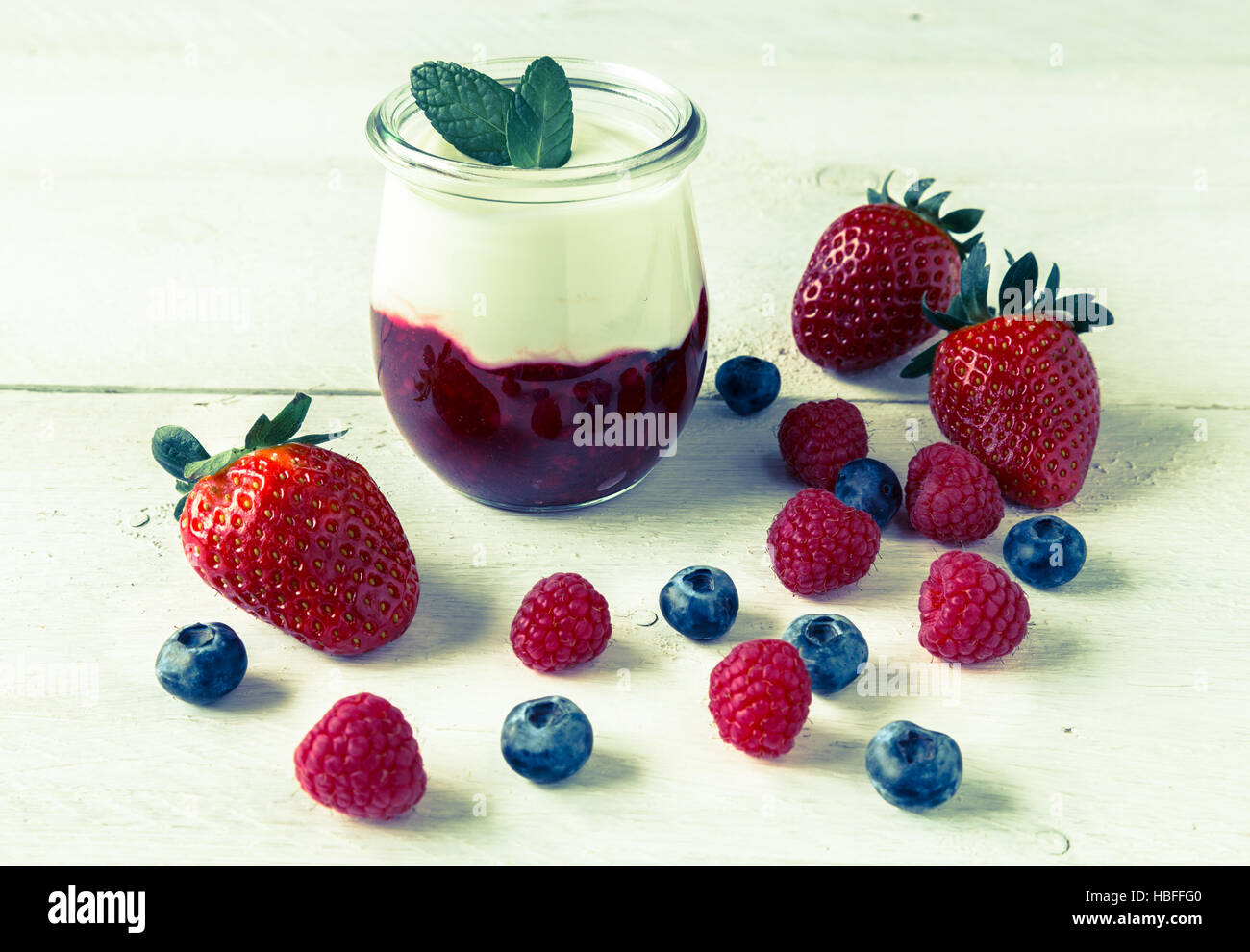 Red fruit compote with mint leaves and fruit Stock Photo - Alamy