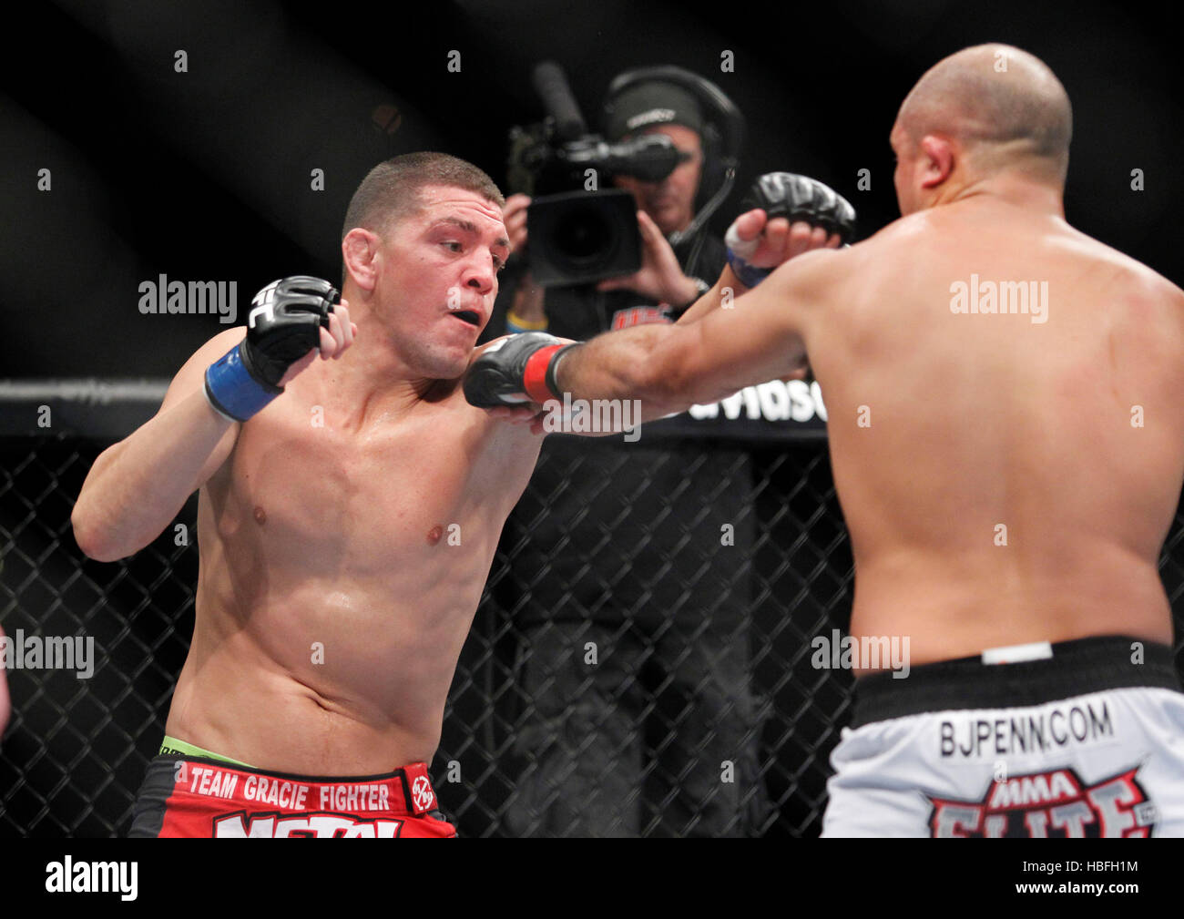 Nick Diaz, left, punches BJ Penn during UFC 137 at the Mandalay Events ...