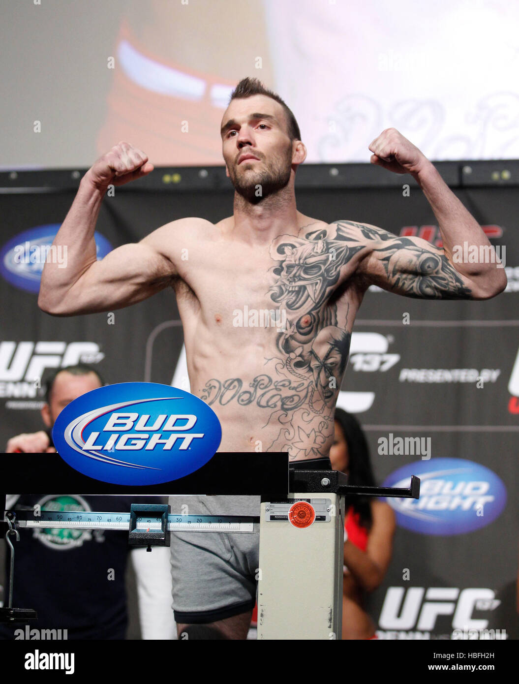 UFC fighter George Roop on the scale during a weigh-in for UFC 137 in ...