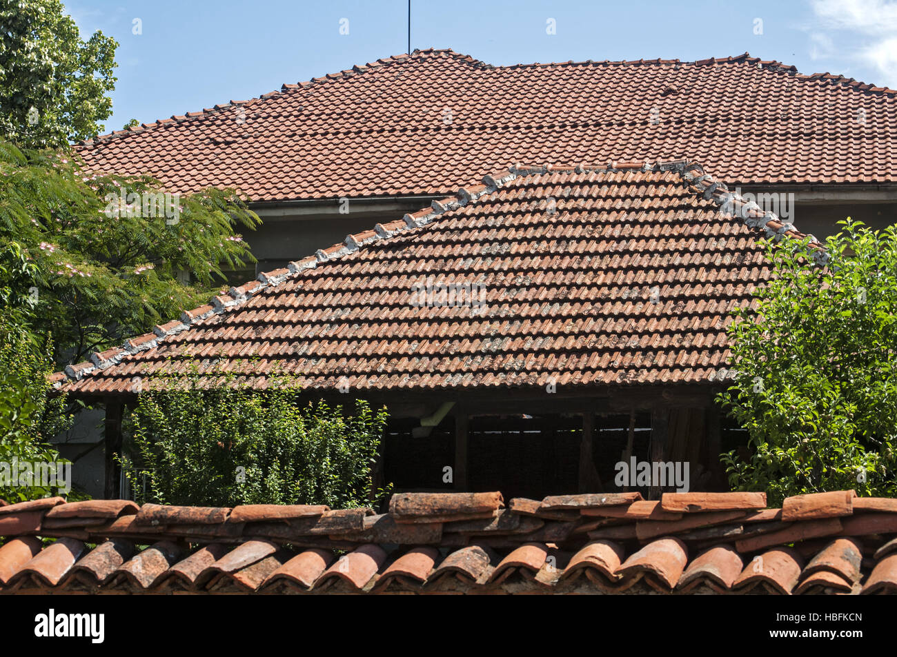 Fence and tile roofs of country house Stock Photo - Alamy