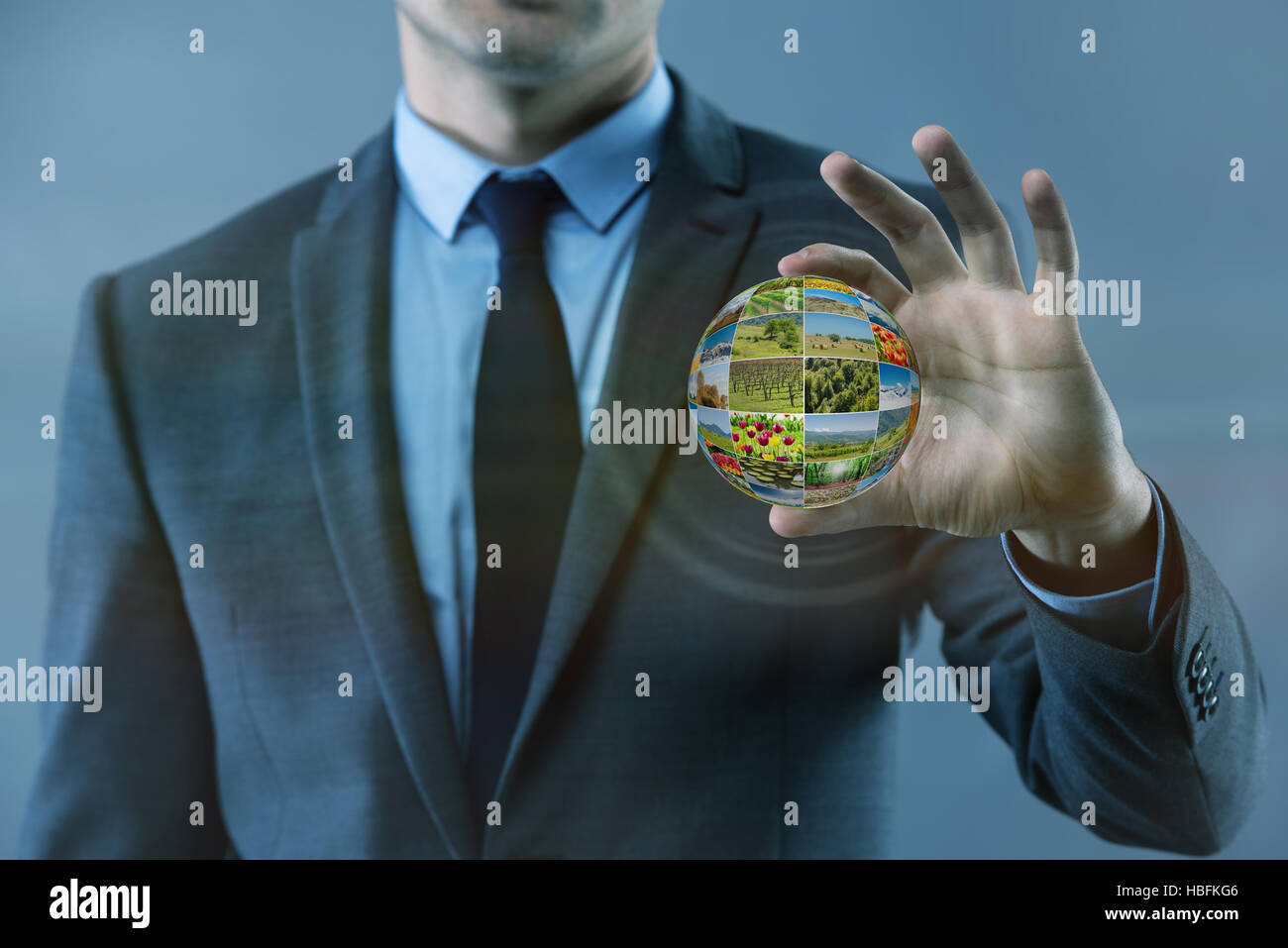 Man holding earth with nature photos Stock Photo - Alamy
