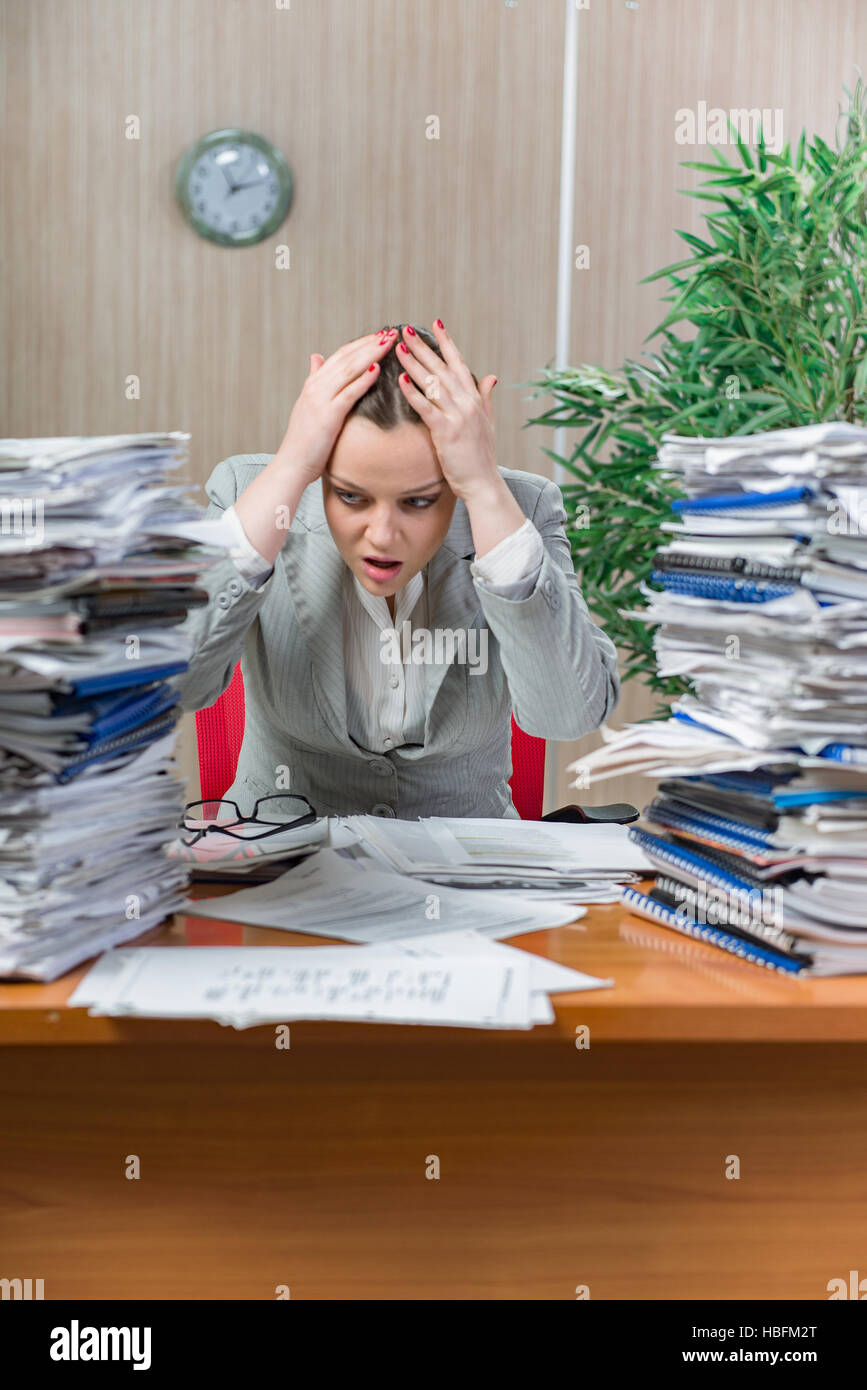 Woman under stress from excessive paper work Stock Photo - Alamy