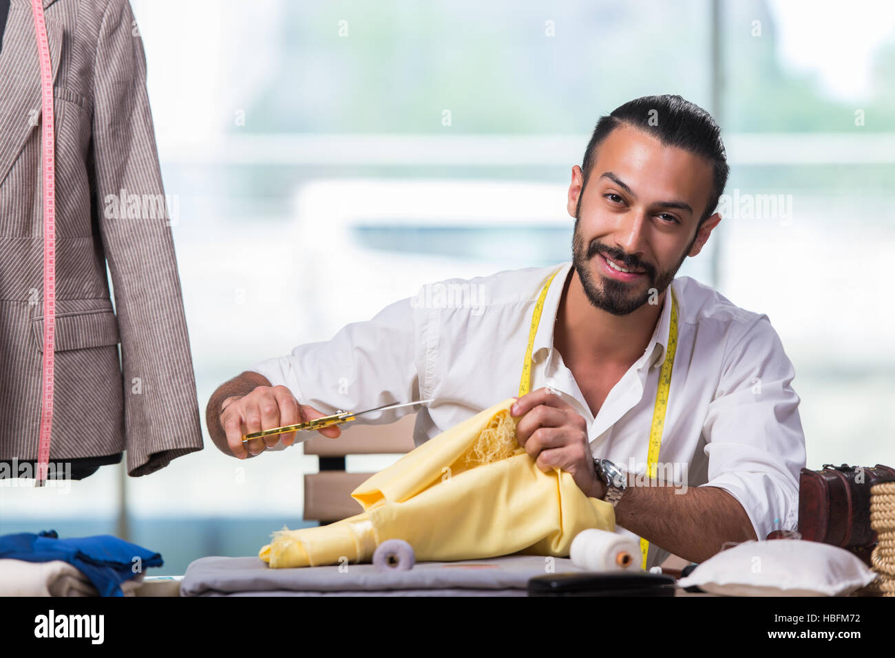 Young tailor working on new clothing design Stock Photo - Alamy