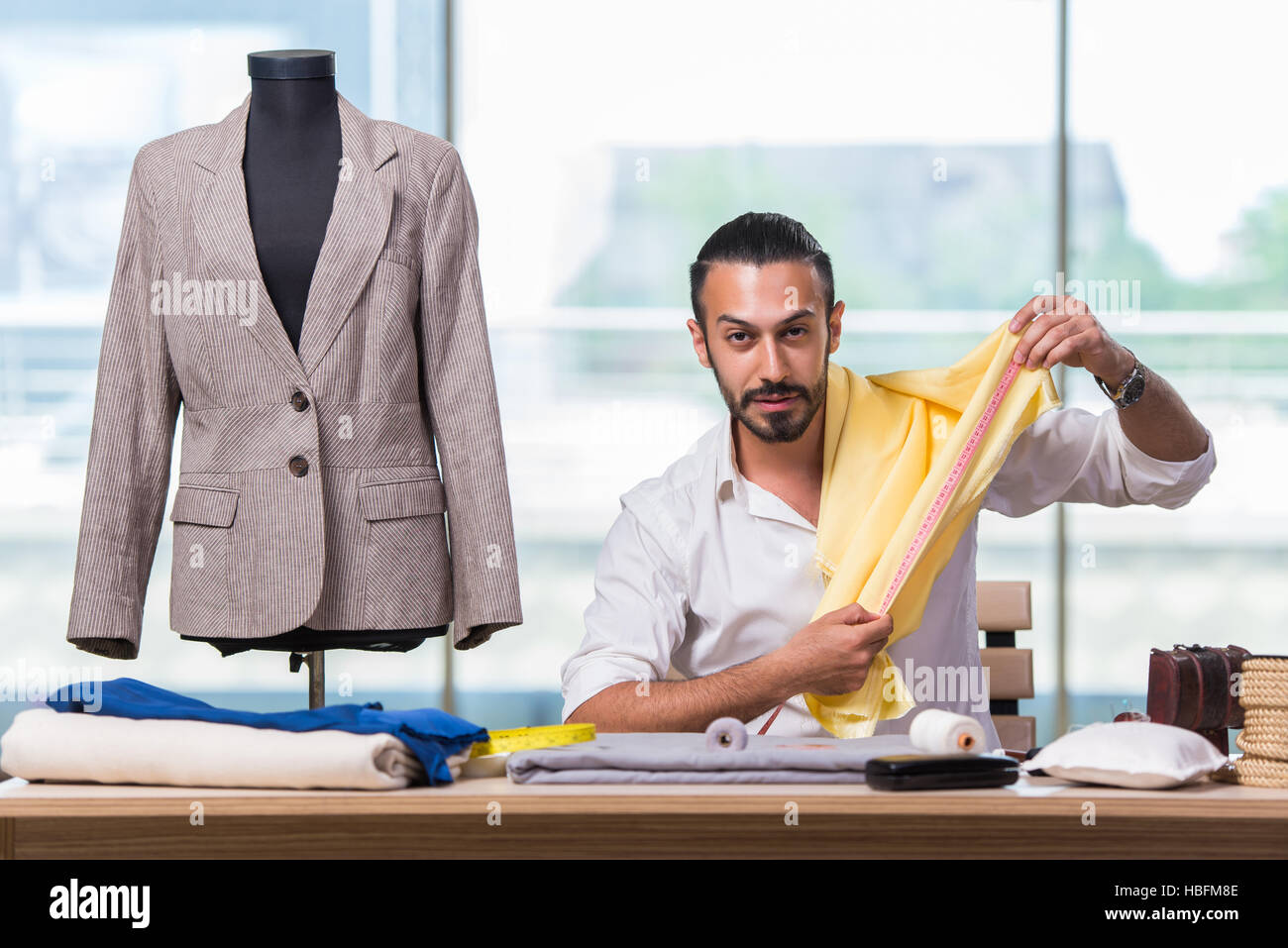 Young tailor working on new clothing design Stock Photo - Alamy