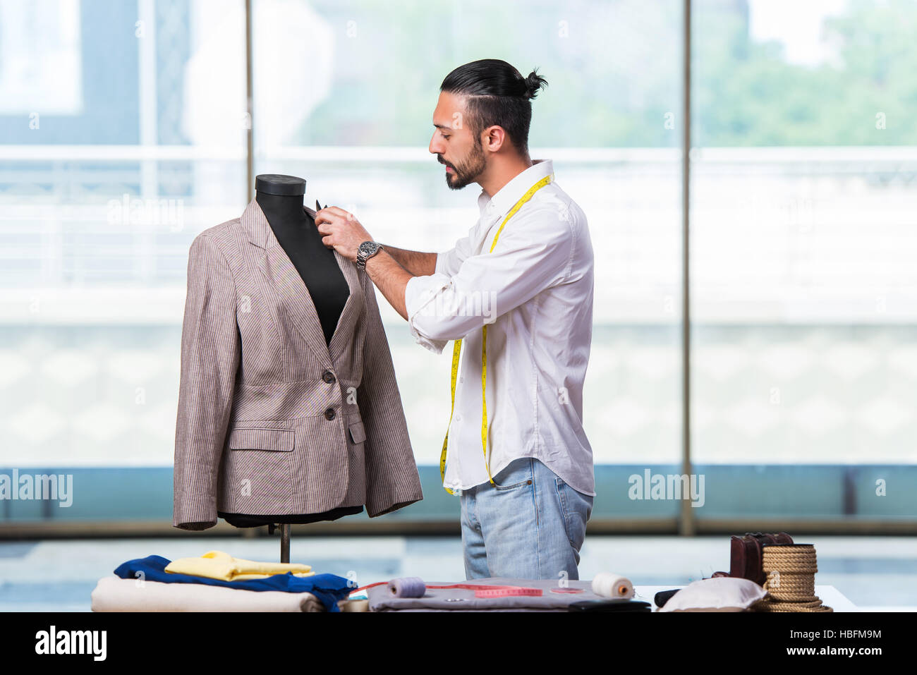 Young tailor working on new clothing design Stock Photo - Alamy
