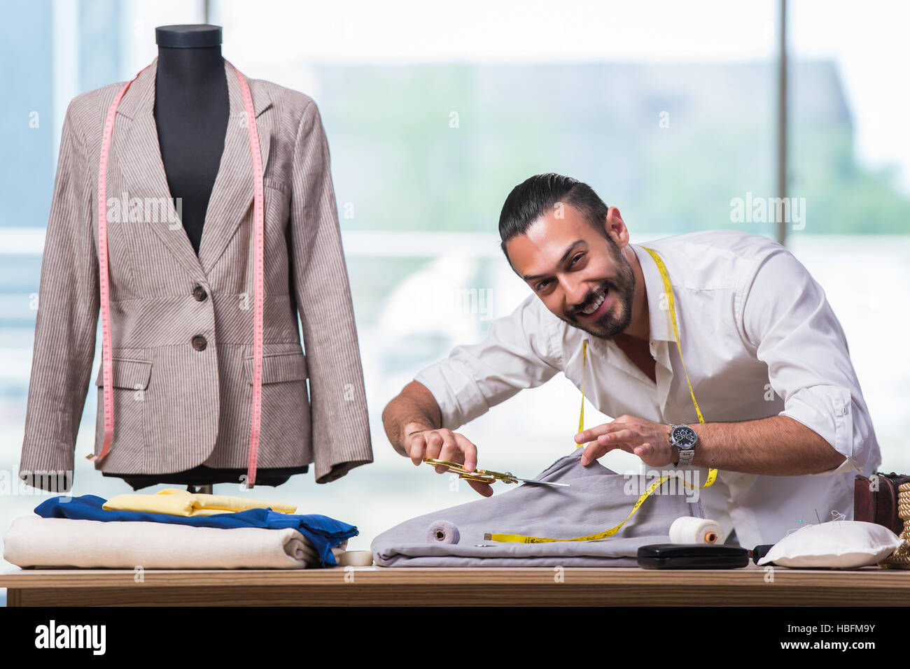Young tailor working on new clothing design Stock Photo - Alamy