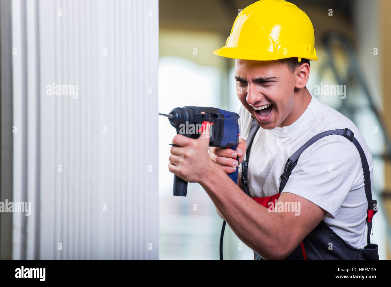Man drilling the wall with drill perforator Stock Photo - Alamy