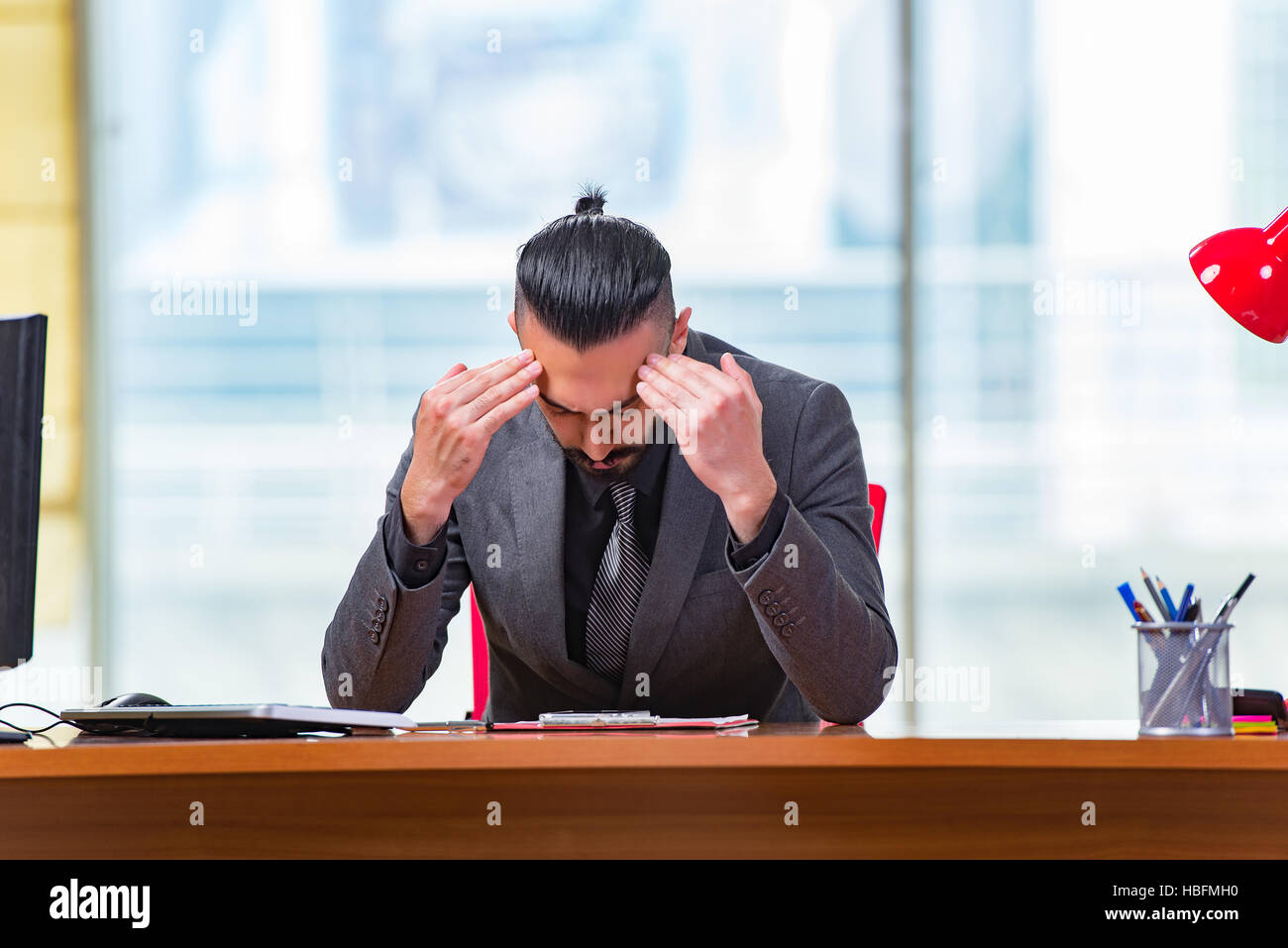 Sad businessman sitting in the office Stock Photo - Alamy
