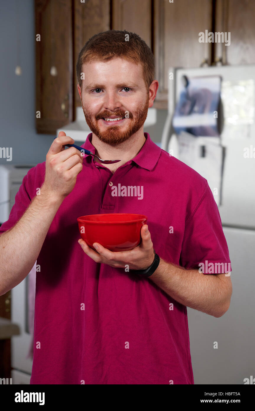 Handsome young man eating cereal hi-res stock photography and images ...
