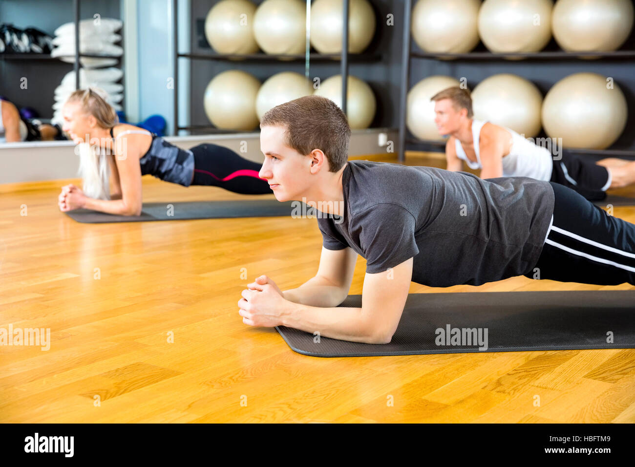 Man Performing Plank Exercise With Friends Stock Photo - Alamy