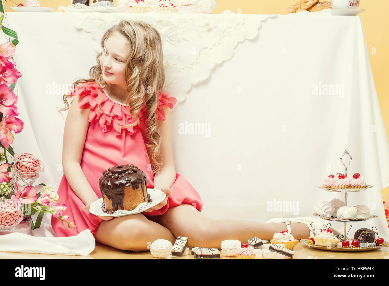 Smiling elegant girl posing with tasty cakes Stock Photo - Alamy