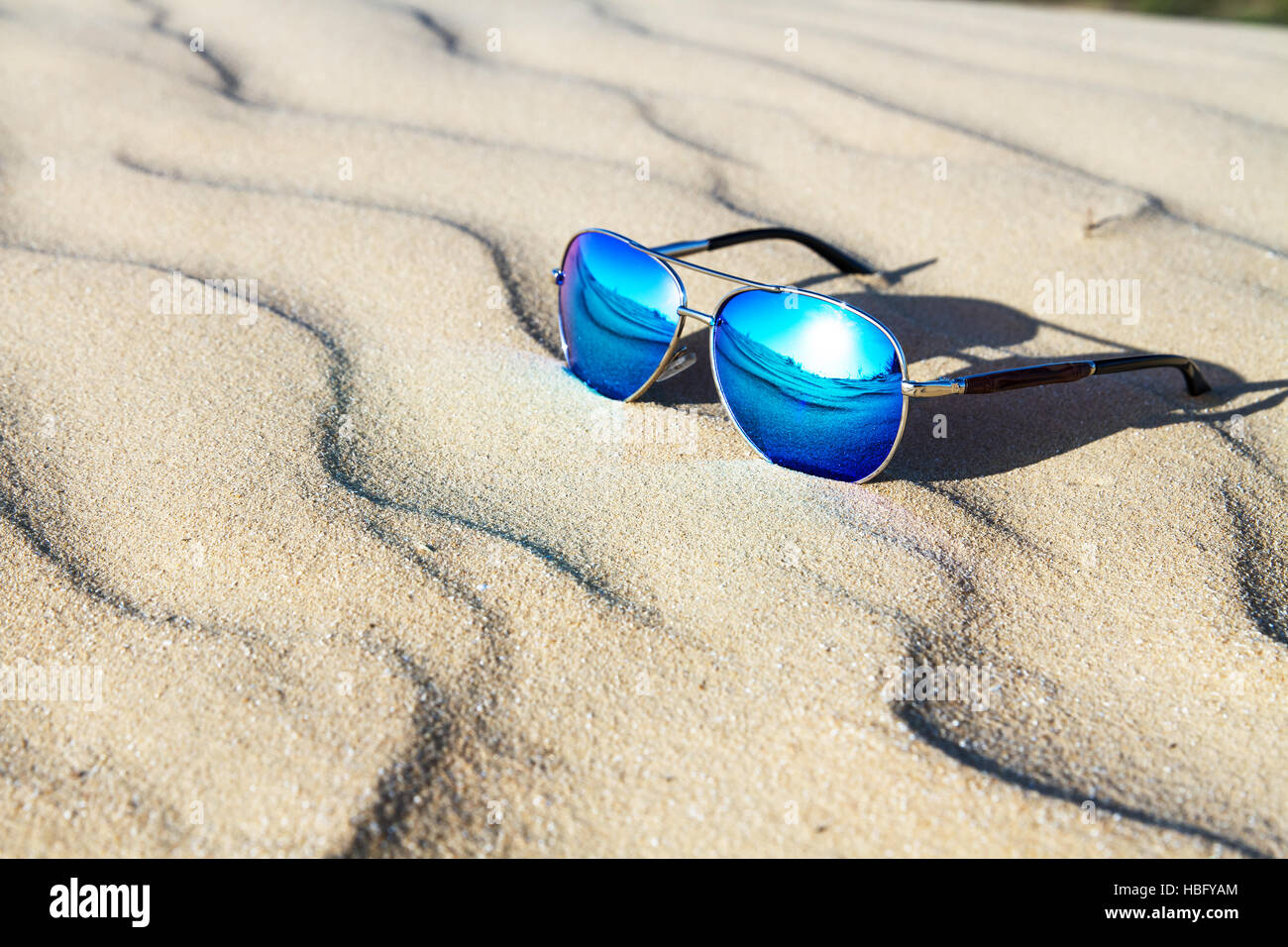 Sunglasses on the sand in the desert Stock Photo - Alamy