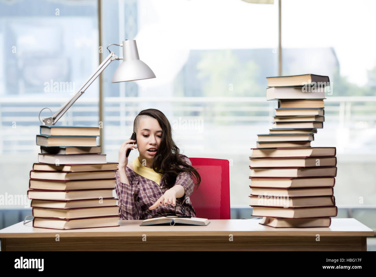 Young student with stack of books Stock Photo - Alamy