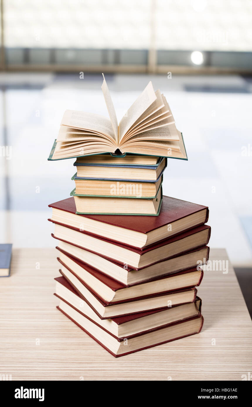 Stack of books arranged the office desk Stock Photo - Alamy