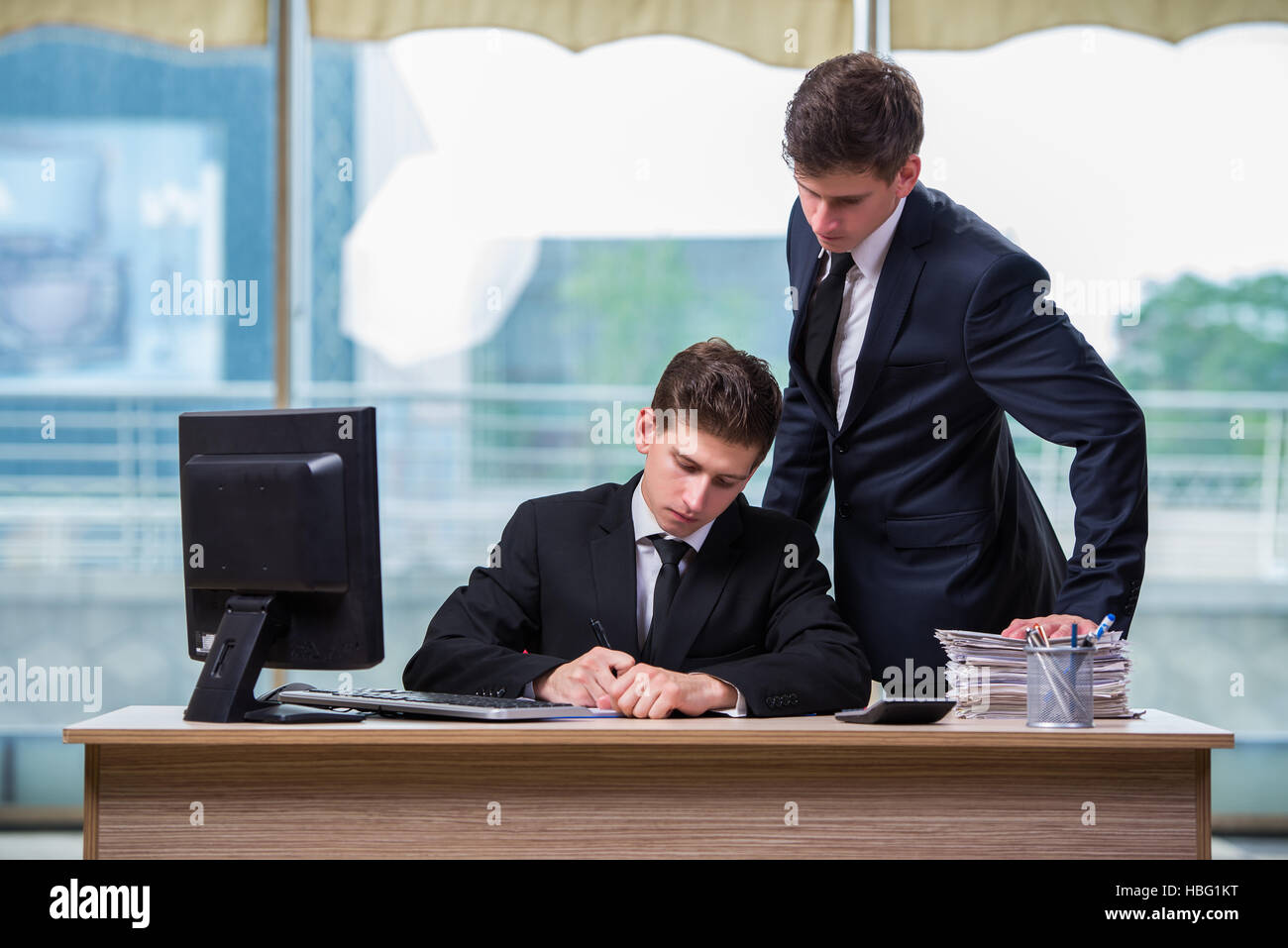 Two twin brothers discussing business project Stock Photo - Alamy