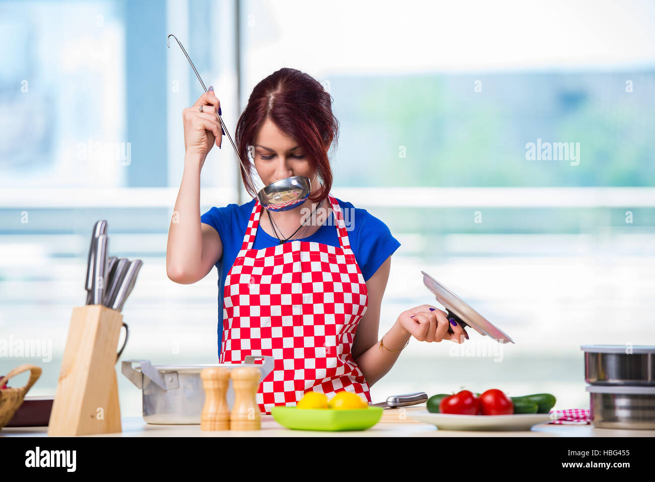 Young cook working in the kitchen Stock Photo - Alamy