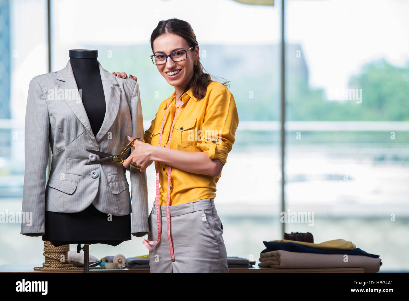 Woman tailor working on new clothing Stock Photo - Alamy