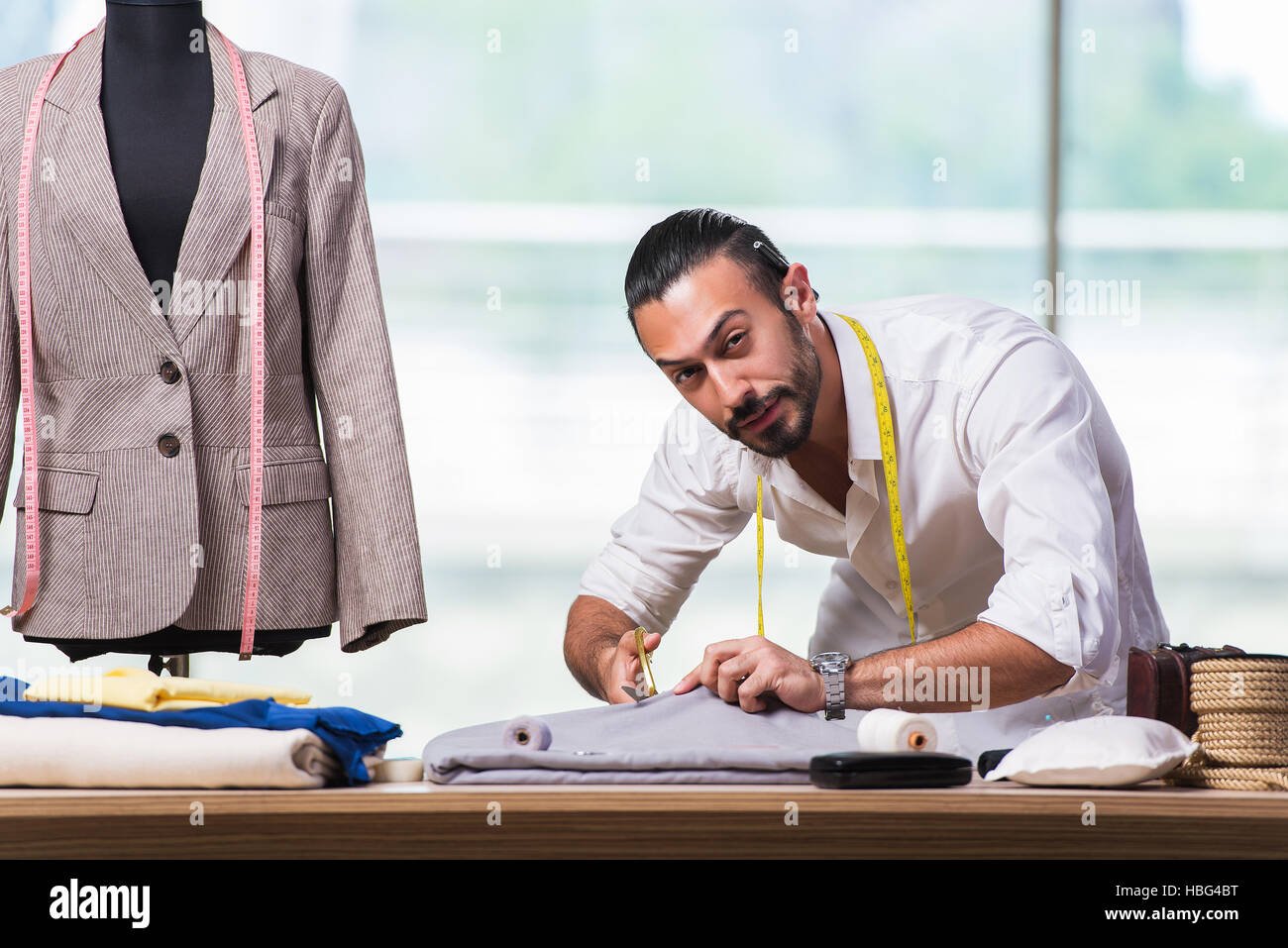 Young tailor working on new clothing design Stock Photo - Alamy