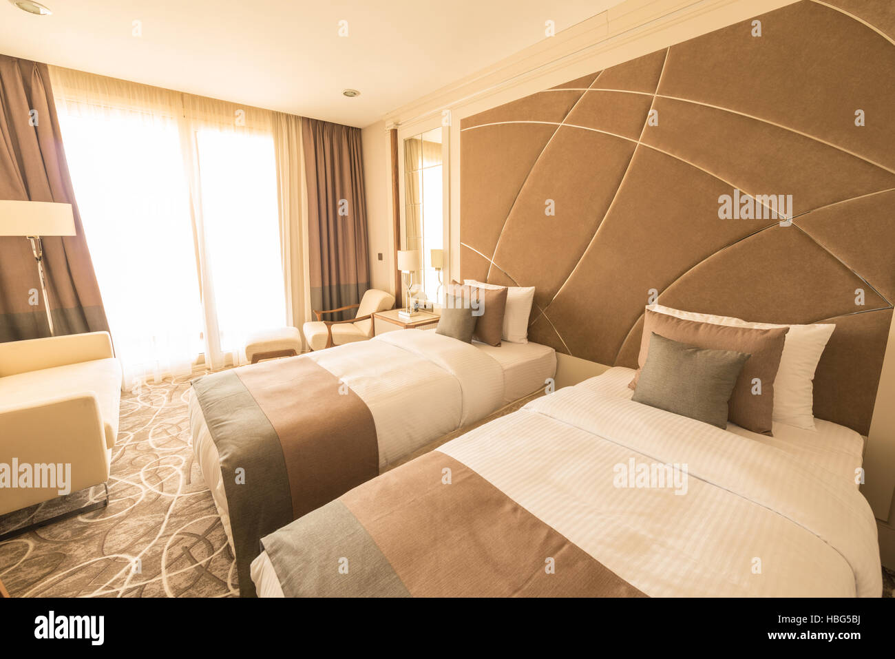 Modern hotel room with big bed Stock Photo - Alamy