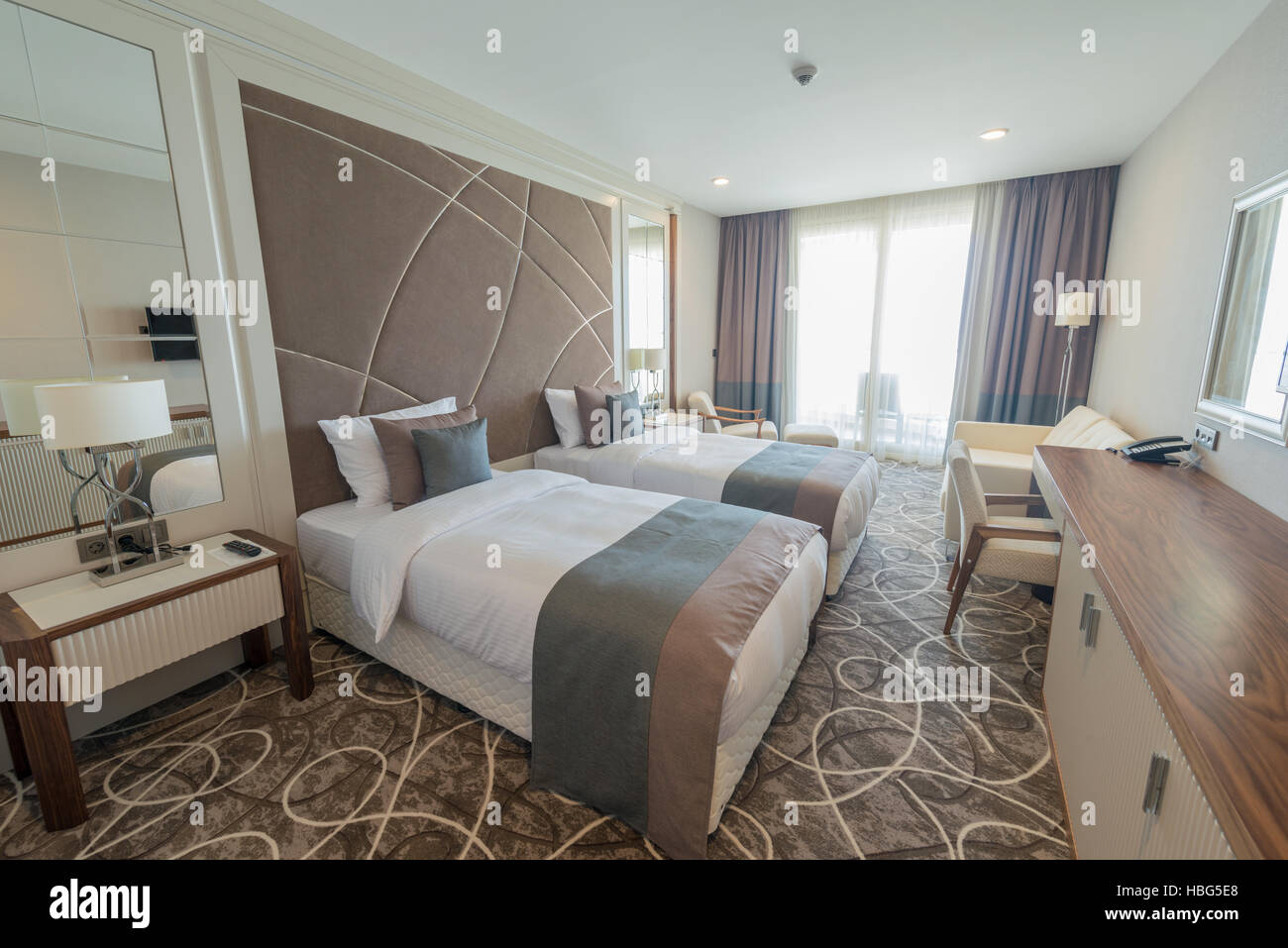 Modern hotel room with big bed Stock Photo - Alamy