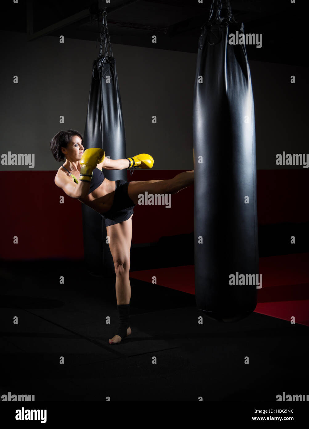 Training of kickboxer woman at sports hall Stock Photo - Alamy