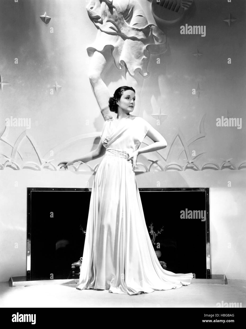 ARTISTS AND MODELS, Gail Patrick, modeling a pink satin gown by Travis ...