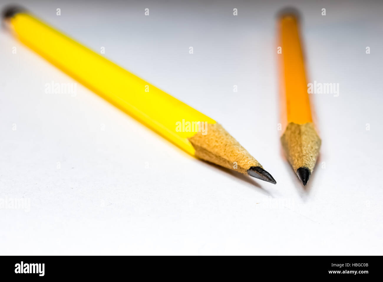 Two pencils resting on white paper Stock Photo - Alamy