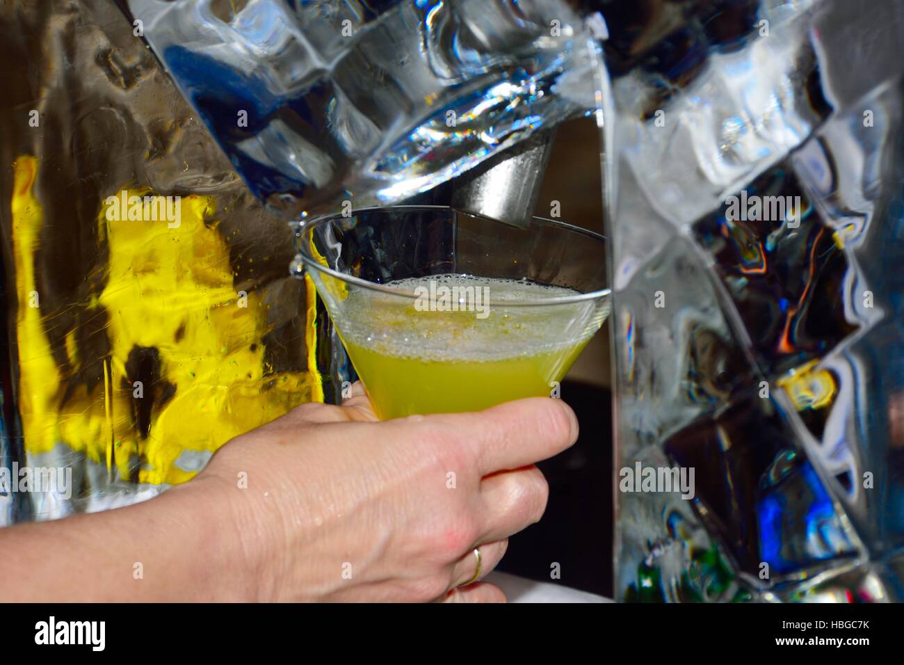 Cocktail being poured out into glass Stock Photo - Alamy