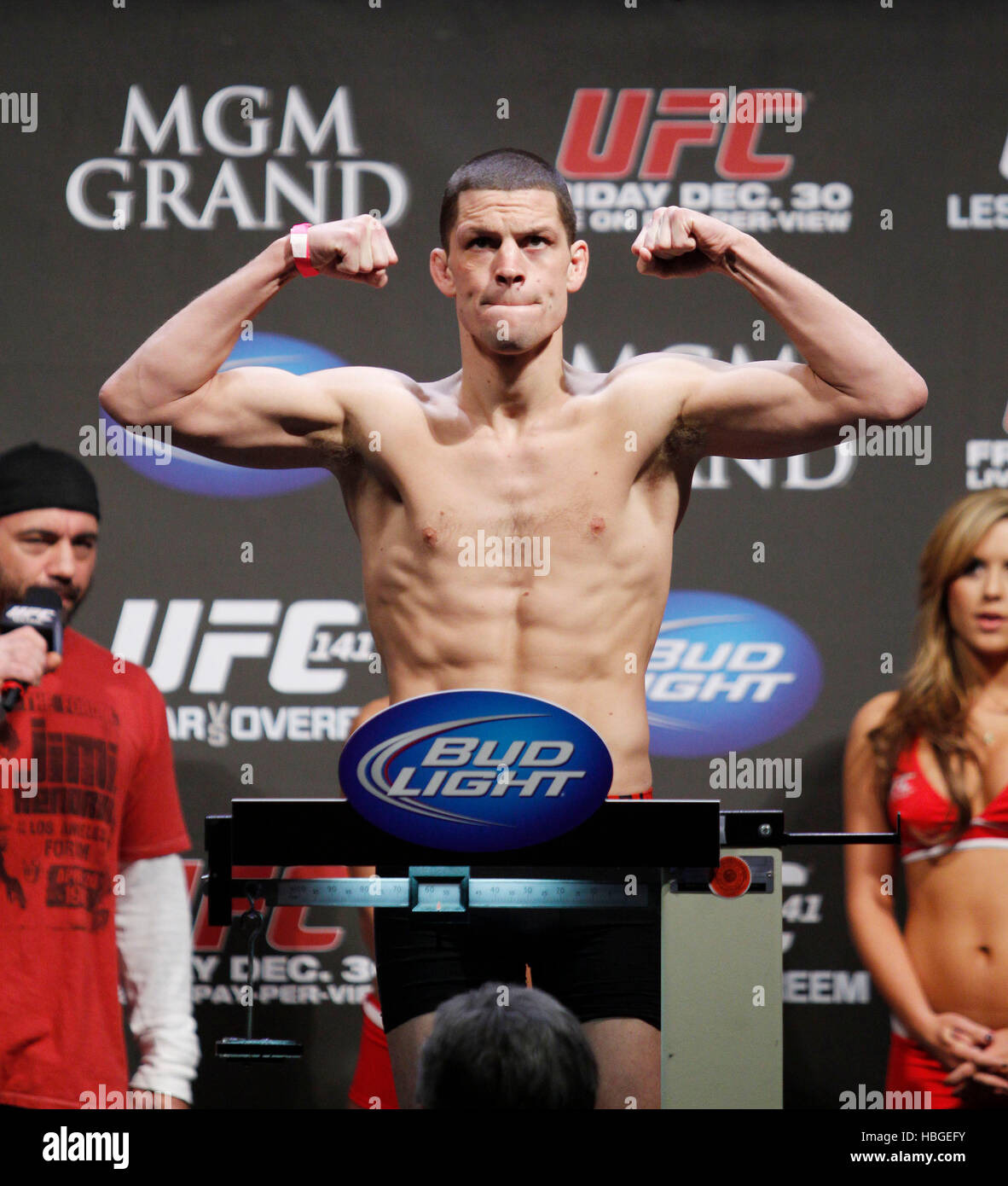 UFC fighter Nate Diaz steps on the scale at the weigh-ins for UFC 141 ...