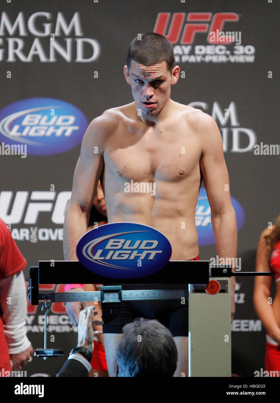 UFC fighter Nate Diaz steps on the scale at the weigh-ins for UFC 141 ...