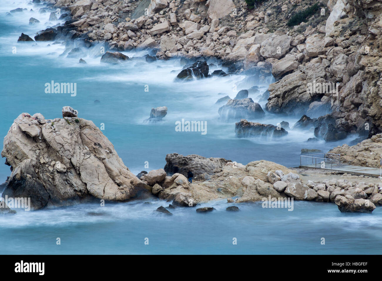 Ocean scene with rocks and slow shutter speed giving surreal misty ...