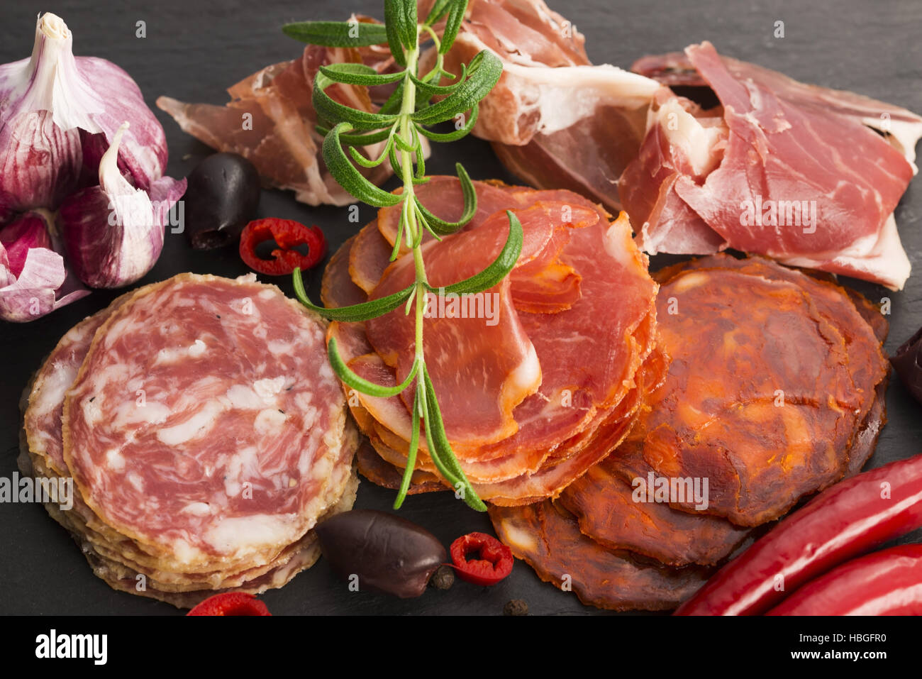 a pile of different spanish embutido, jamon, chorizo and lomo embuchado ...