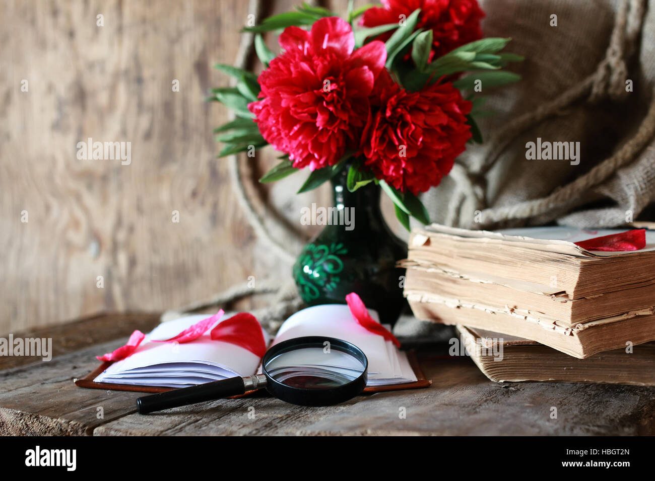 old book flower on wooden table Stock Photo - Alamy