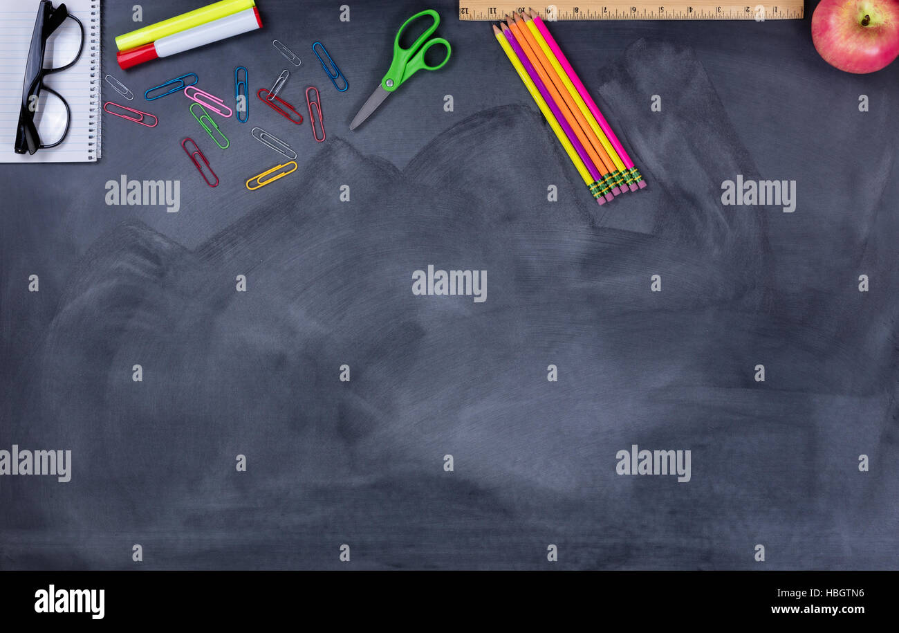 Student school supplies on erased chalkboard Stock Photo - Alamy