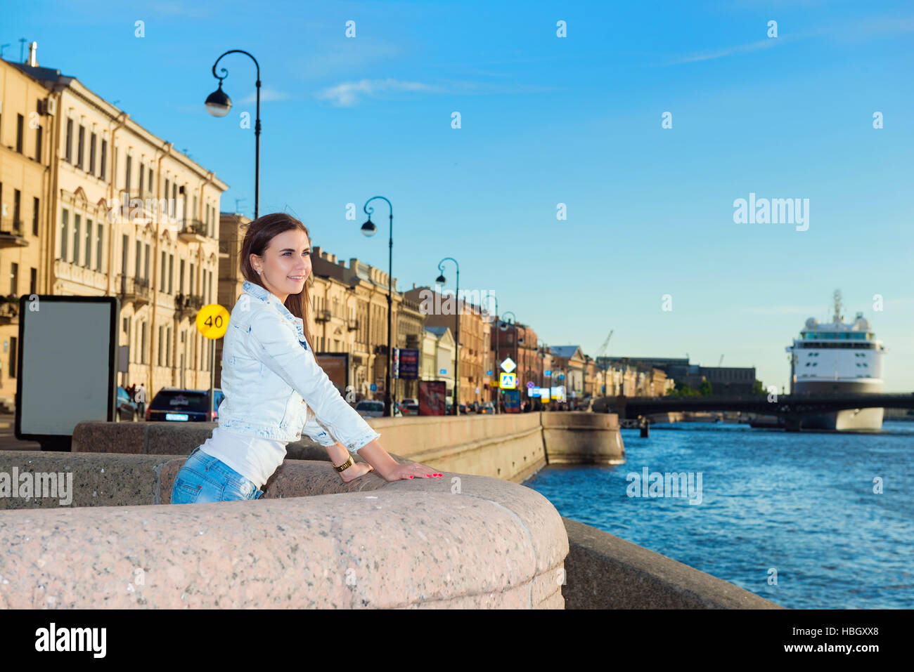 Woman walking along the waterfront Stock Photo - Alamy